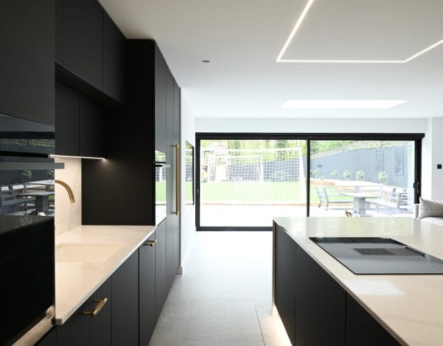 Modern Black German Kitchen with Brass Handles - Classic Interiors